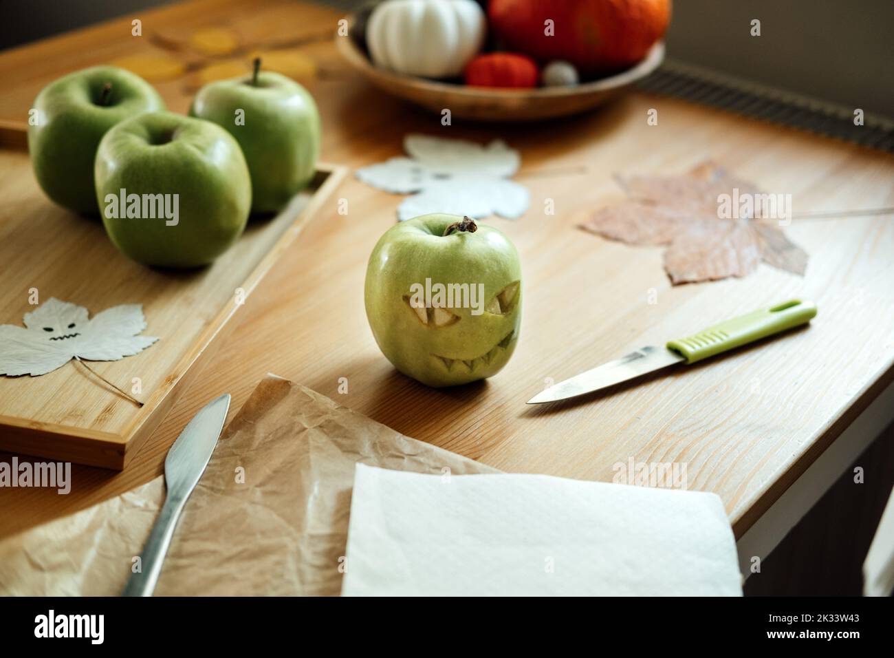 Halloween Fruit ideas. Halloween green apple with creepy carved face on ...