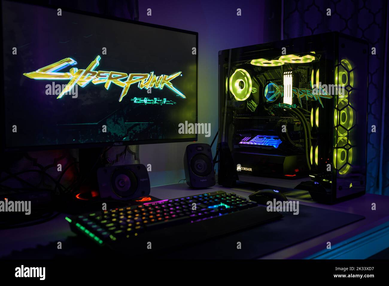 A computer, keyboard, and a Corsair gaming pc with led neon lights ...