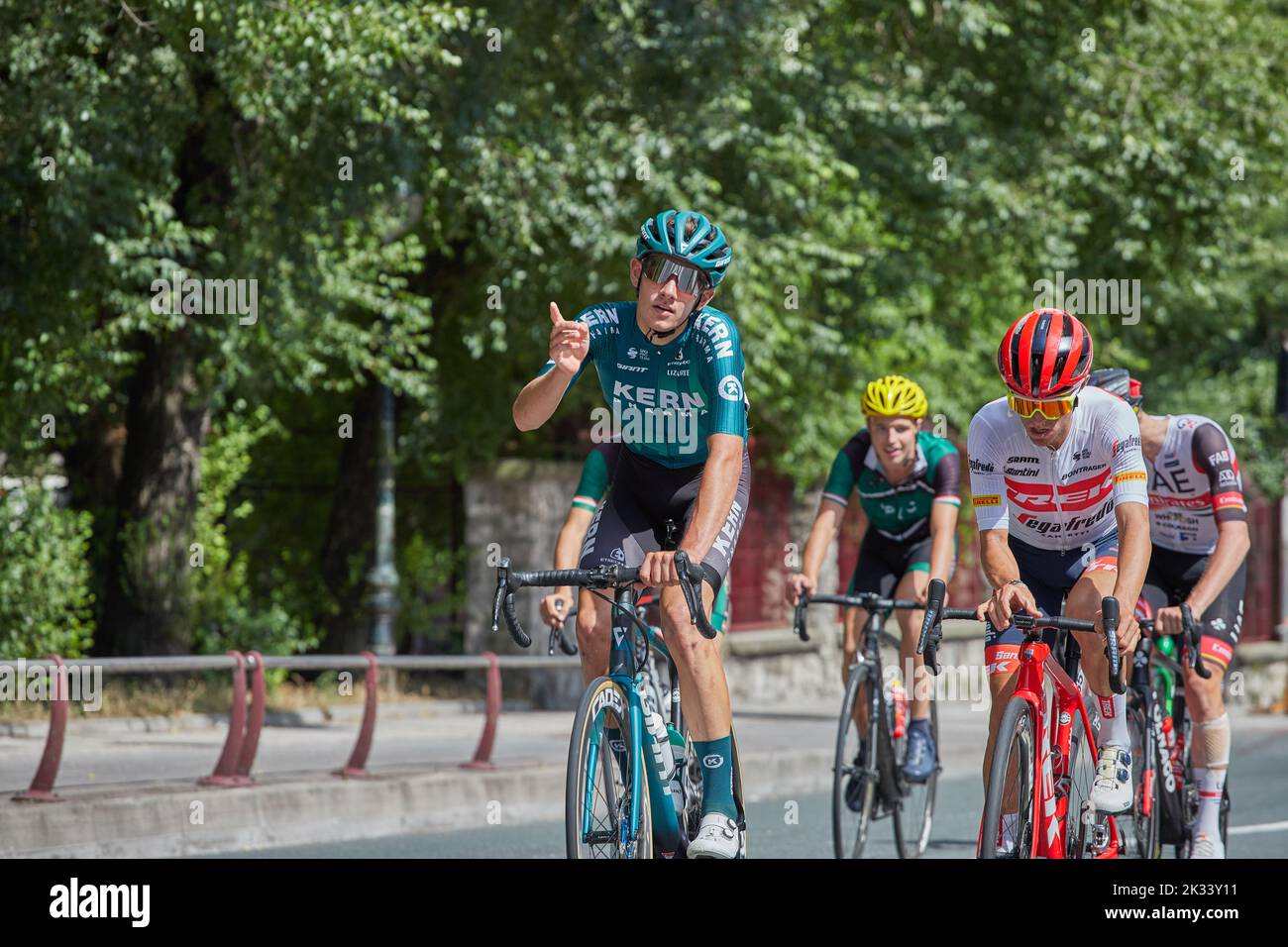 Cyclist pointing the way in Clásica San Sebastián 2022 Stock Photo - Alamy