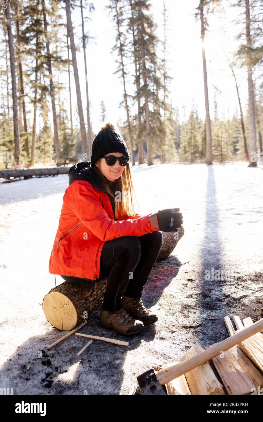 Woman sitting on log hi-res stock photography and images - Alamy