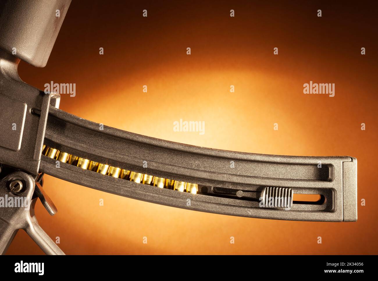 Magazine for a rimfire rifle fully loaded on a beige background Stock ...