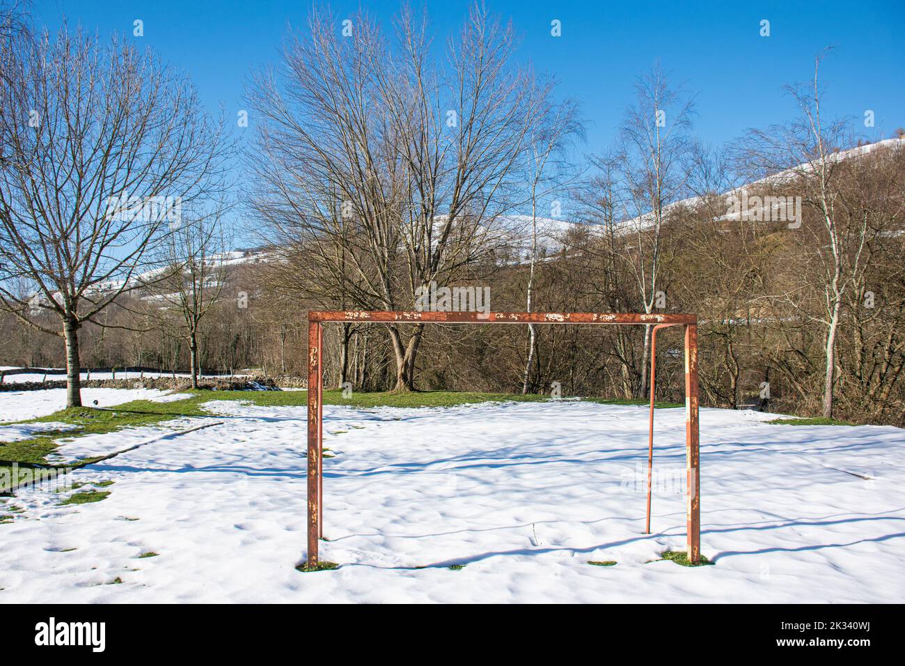 field for playing football in winter with trees and mountains Stock ...