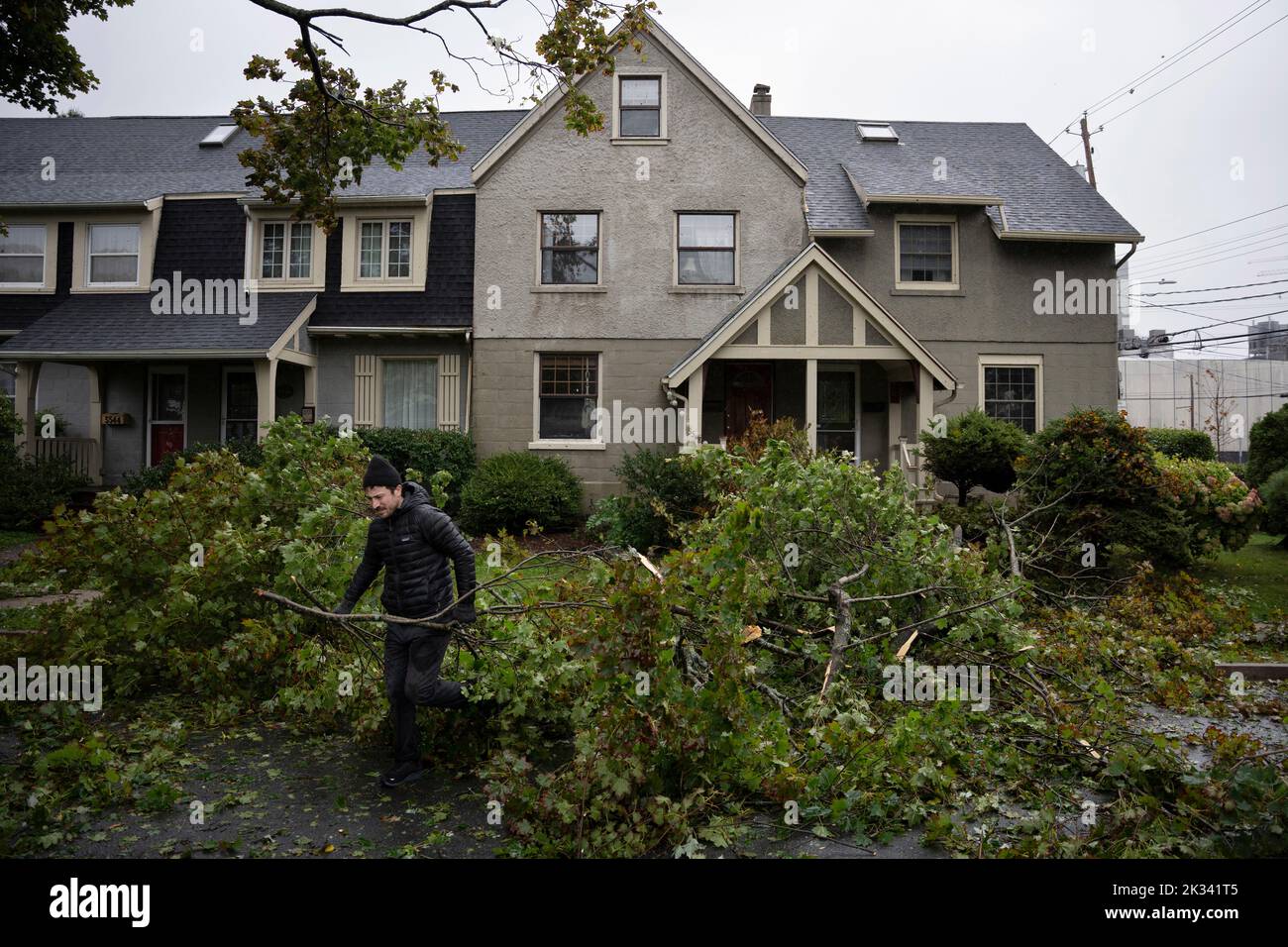 September 24, 2022, Halifax, NS, Canada: A man clears limbs and debris ...