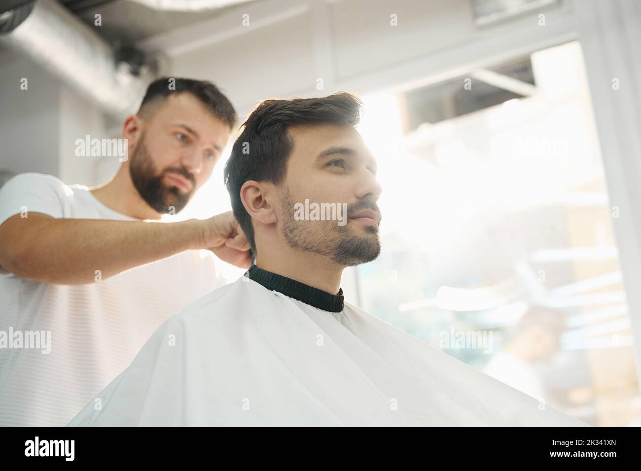 Good-looking guy feeling inspired about getting a fresh haircut Stock ...