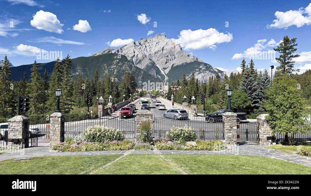 The view of a road with cars and Cascade Mountain in the background ...