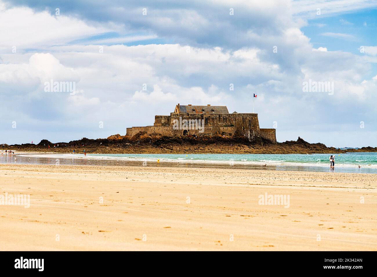 Fort National on tidal island, walkers on the beach, Saint-Malo ...