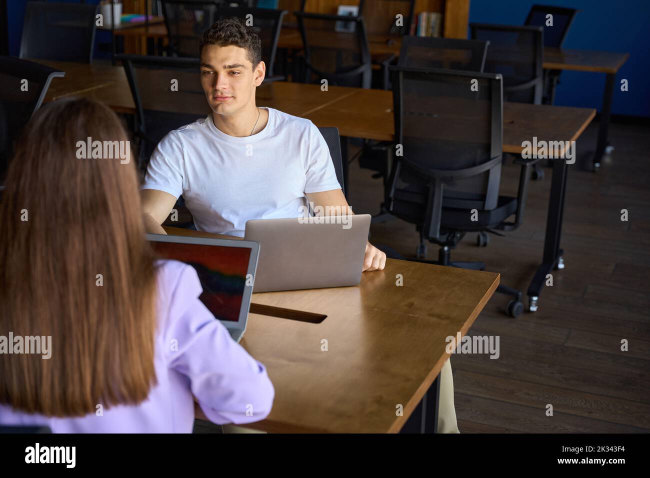 Employee sitting desk opposite client hi-res stock photography and ...