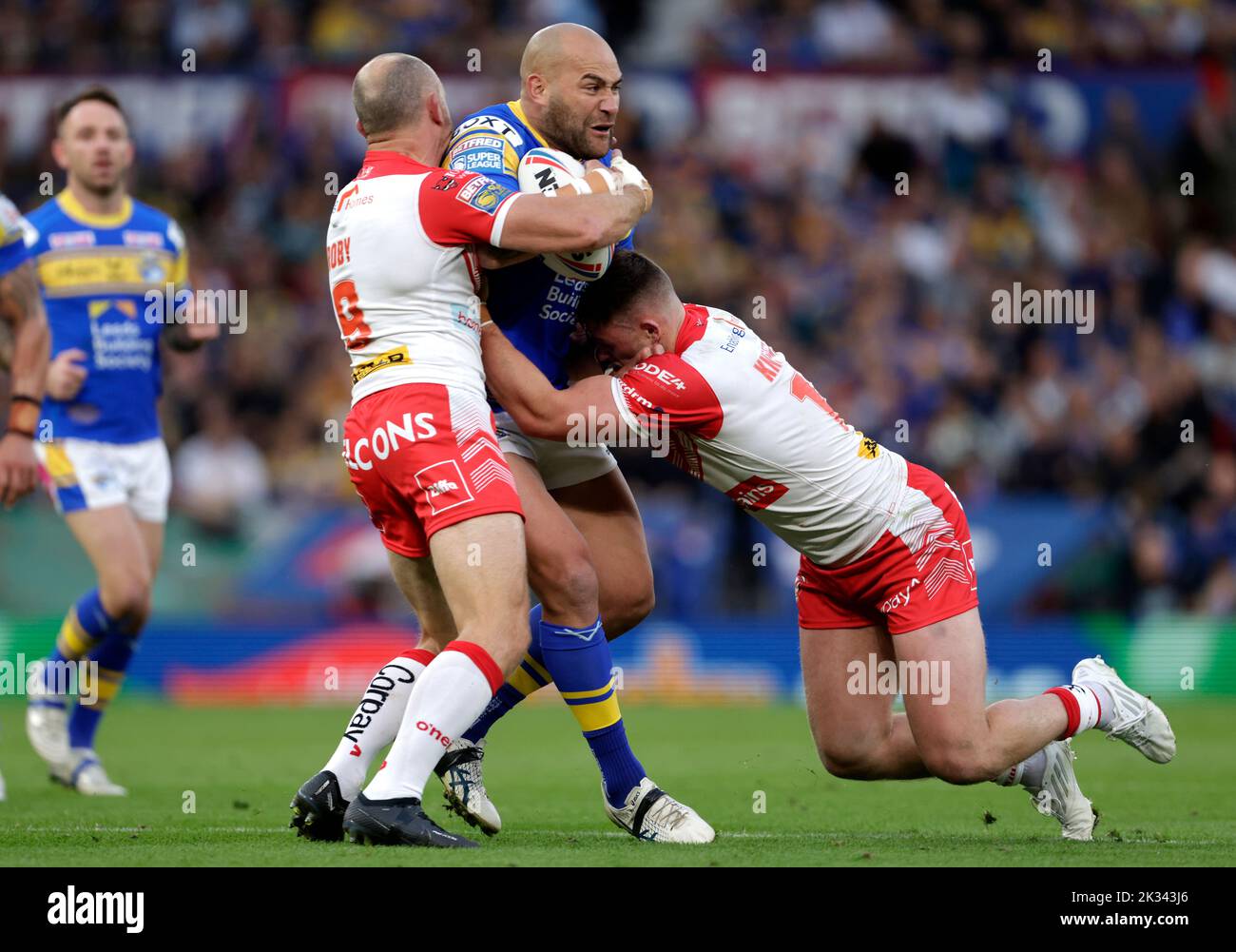 Leeds Rhinos' Bodene Thompson is tackled by St Helens' James Roby and ...