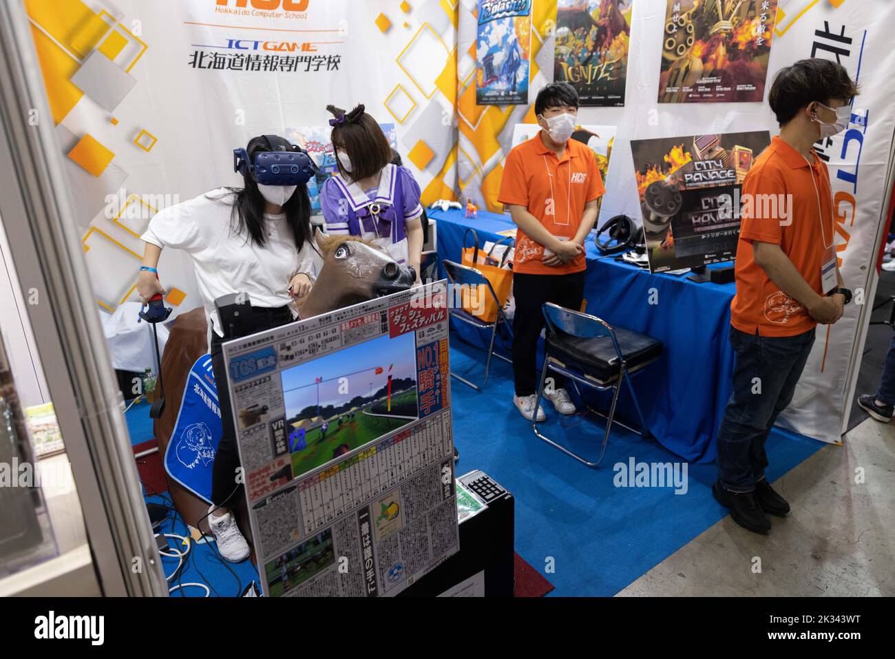 Visitor at the Tokyo Game Show 2022 wears a virtual reality head set ...