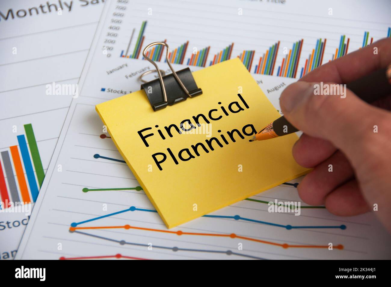 Financial planning text on yellow notepad with financial data analysis ...