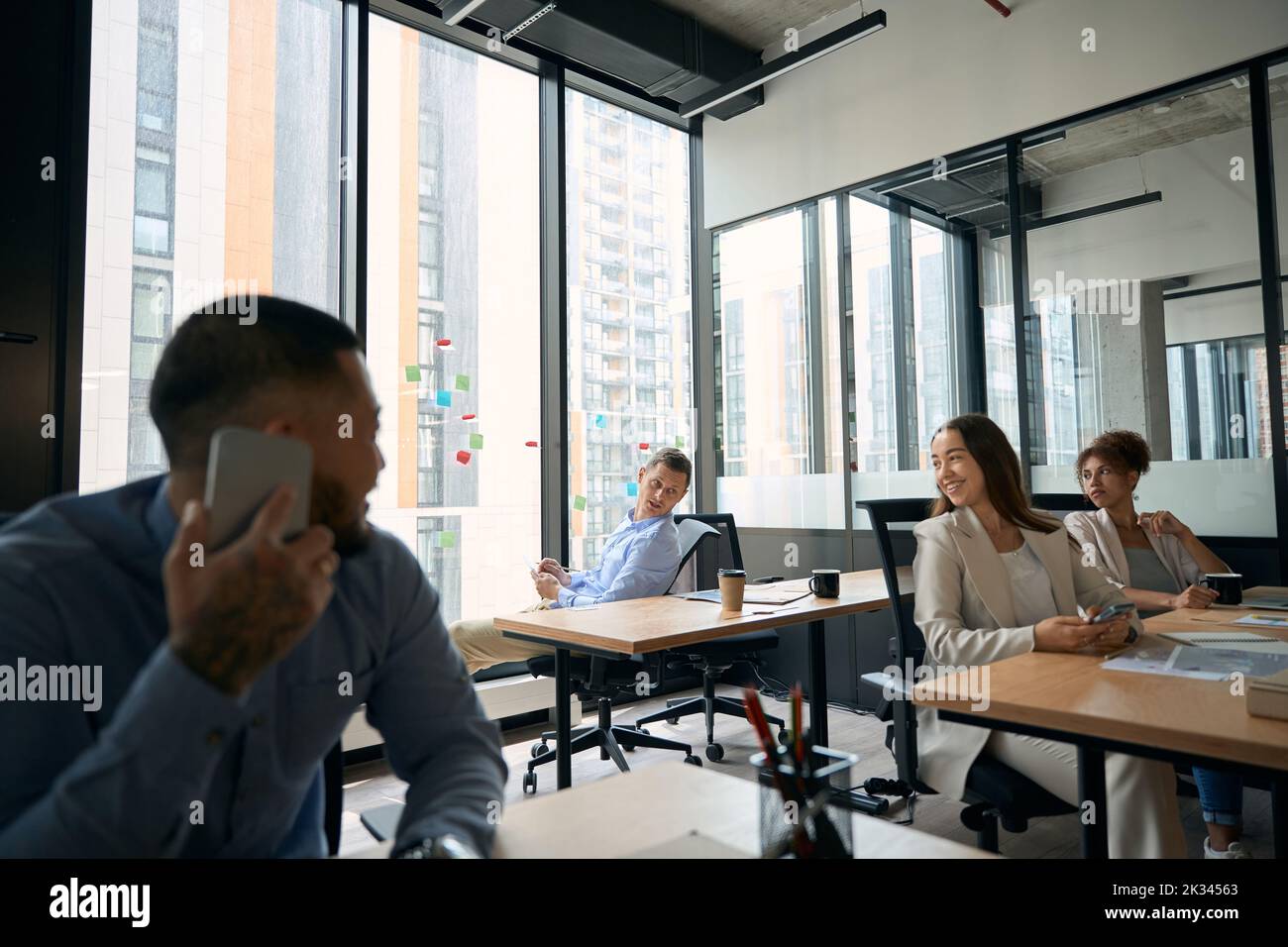 Group of four company employees working together Stock Photo - Alamy