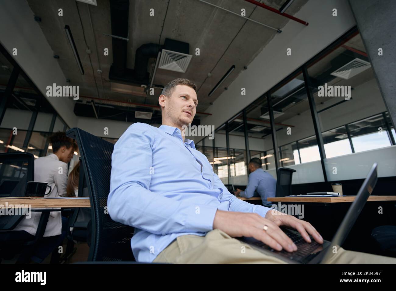 Corporate worker and his colleagues working in company office Stock ...