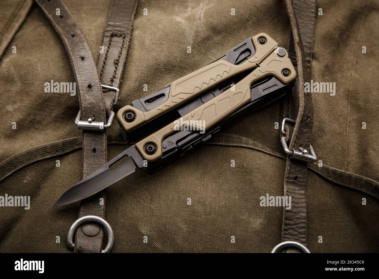 Modern multitool with many tools. A portable multitasking tool on a ...