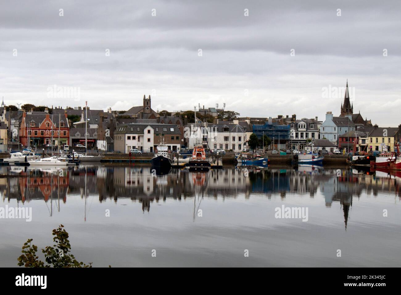 Rows of houses and shops lining the seafront at Stornoway harbour ...