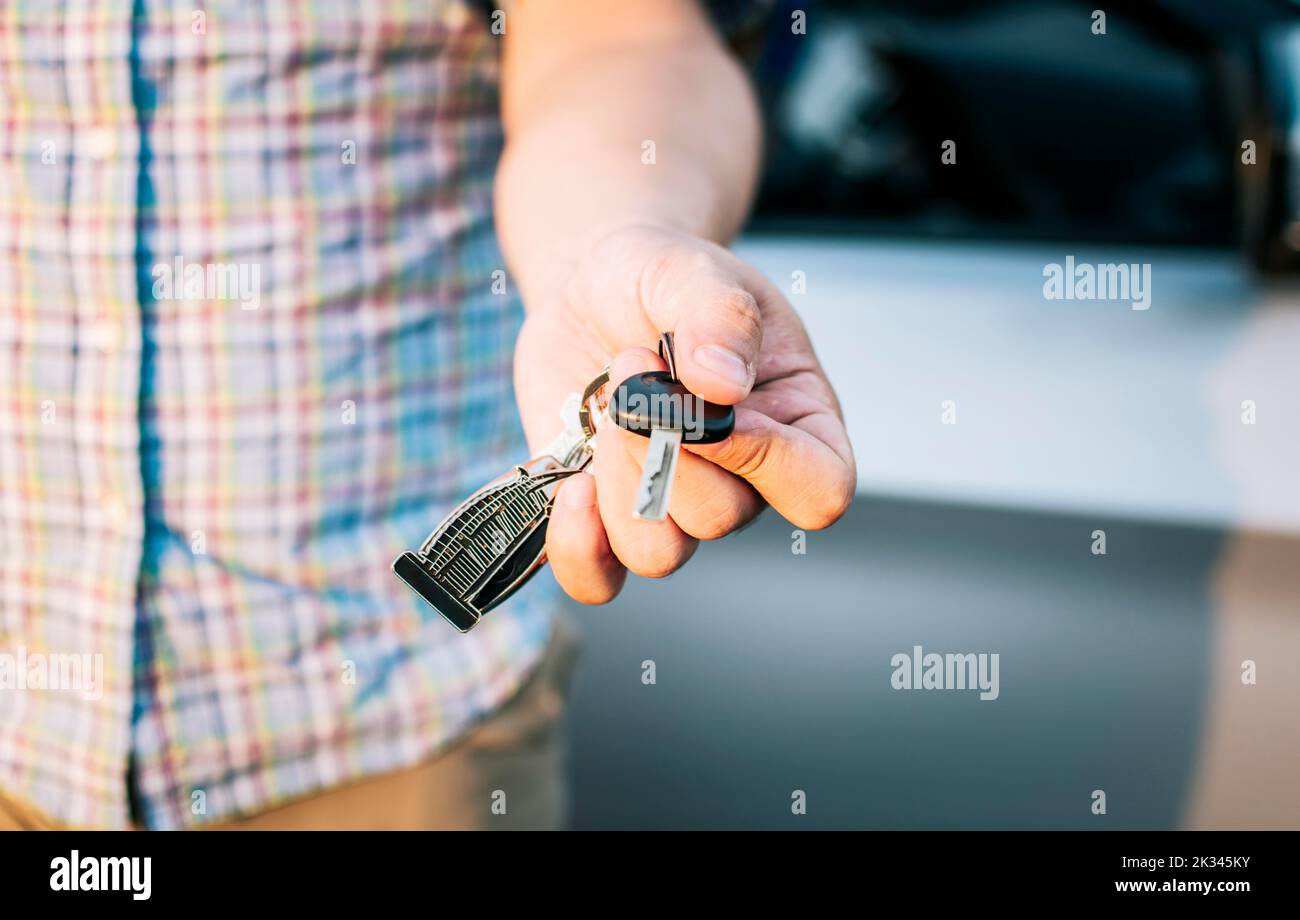 Driver's hands showing the car keys, Close-up of male driver hands ...