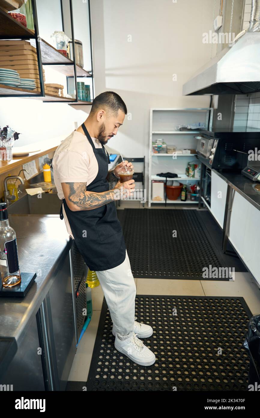 Professional coffee-brewer tasting a beverage in his cafe Stock Photo ...