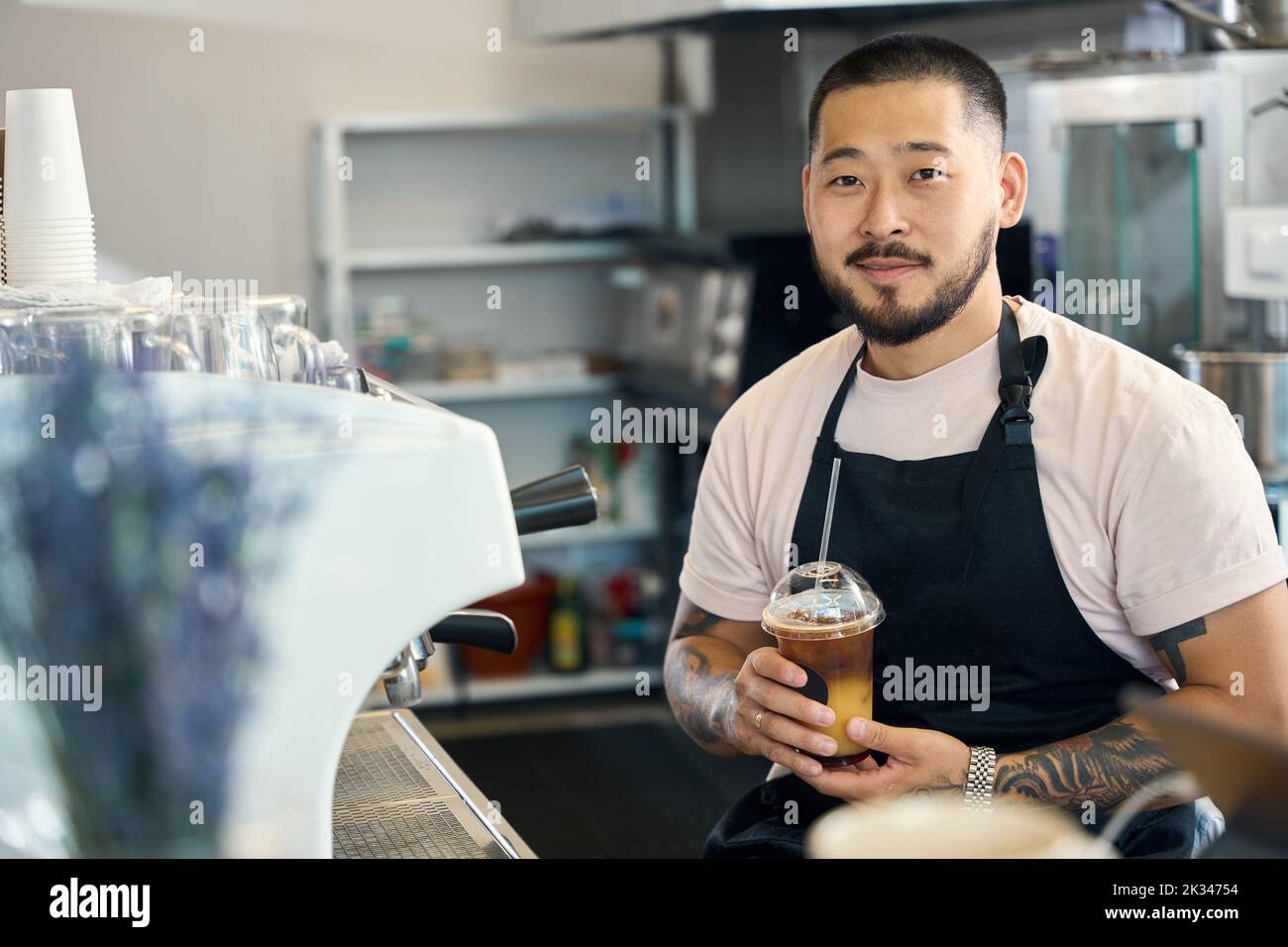 Skilled young man working at a coffee place Stock Photo - Alamy