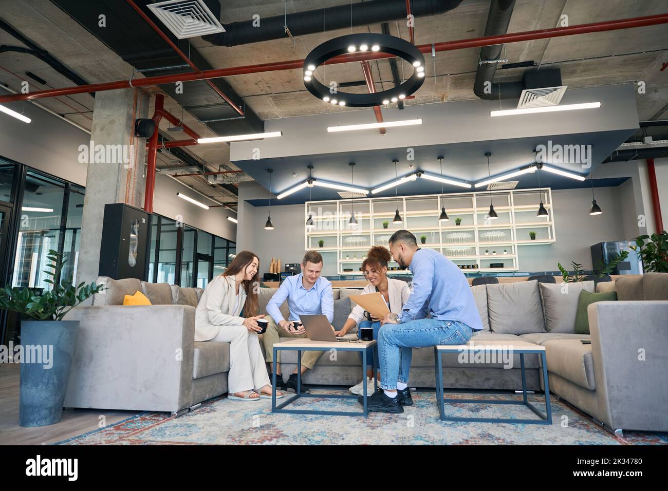 Businesspeople holding business meeting at coffee table in co-working ...