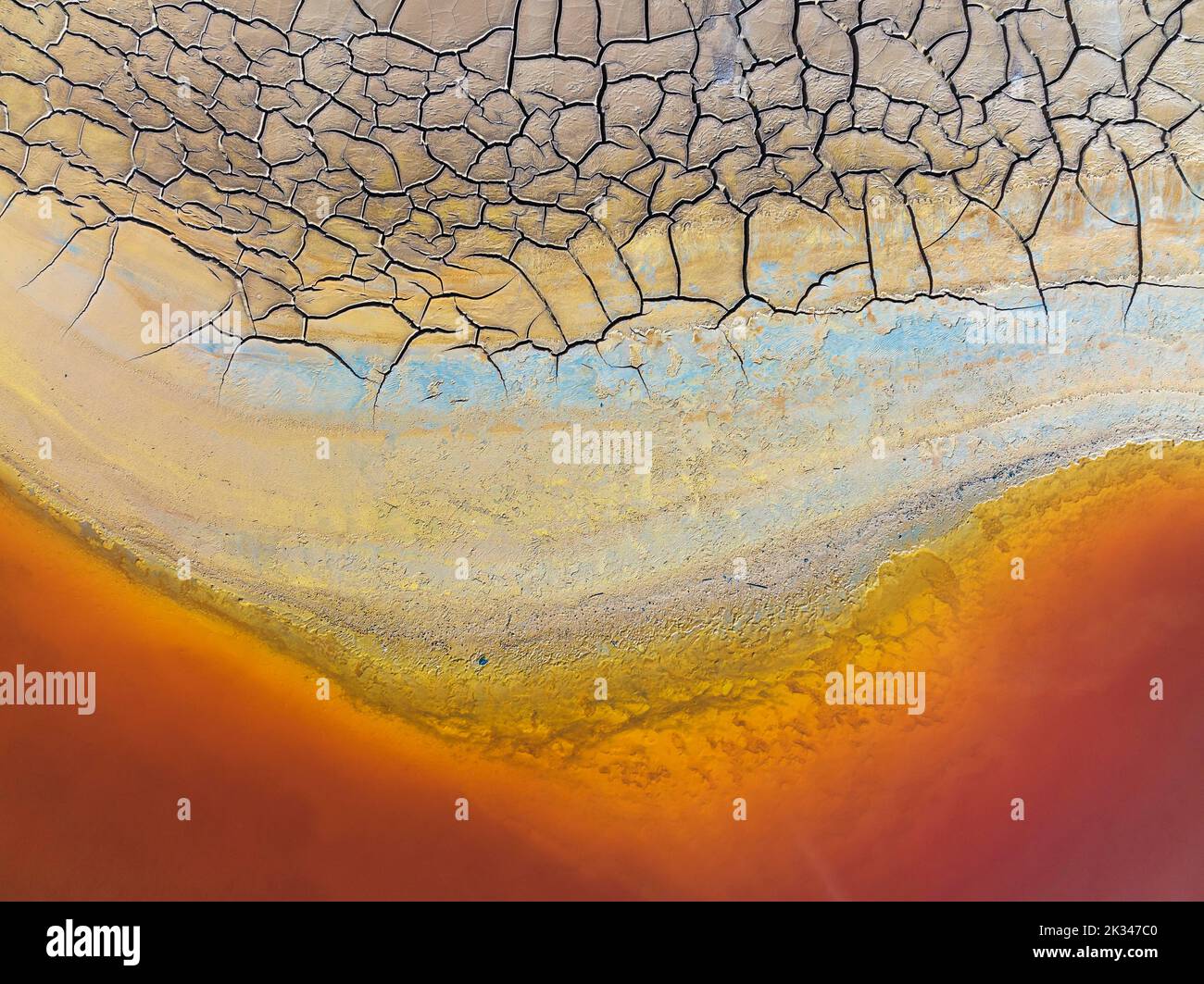 Cracked earth at the bank of the Rio Tinto (Red river) with its deep ...