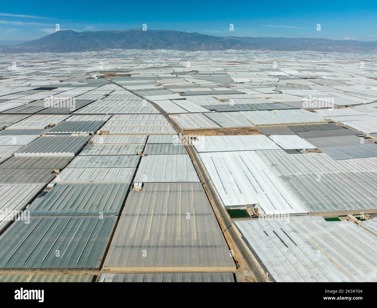 Masses of shimmering plastic greenhouses near El Ejido, aerial view ...