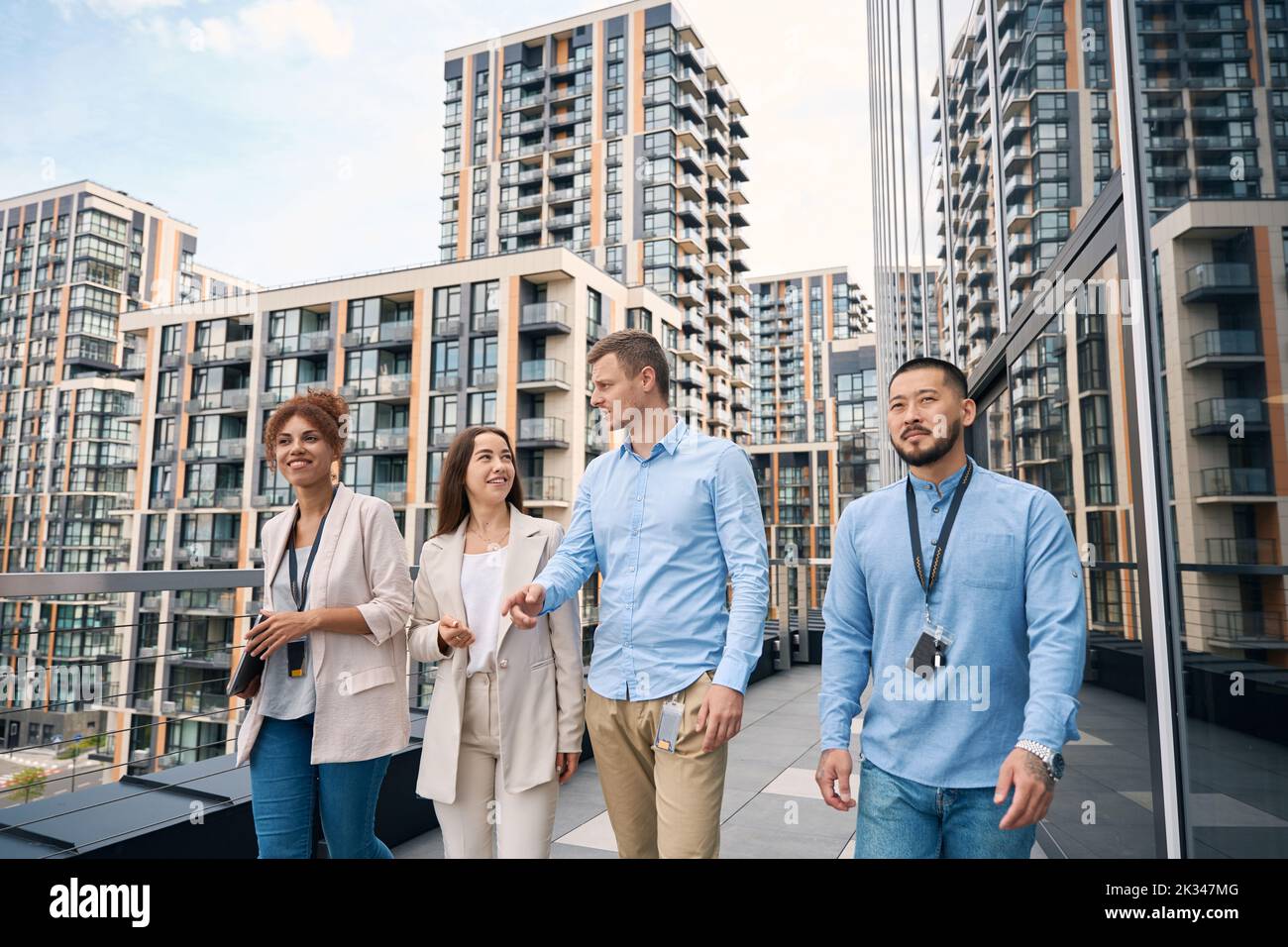 Group of entrepreneurs communicating during outdoor lunchtime walk ...