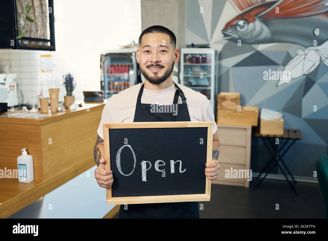 Happy chef presenting a blackboard with written word open on it Stock ...