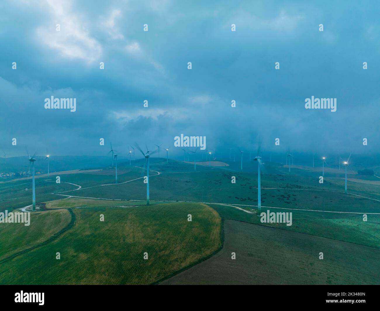 Windmills on a wind farm near Zahara de los Atunes, at a cloudy dawn ...