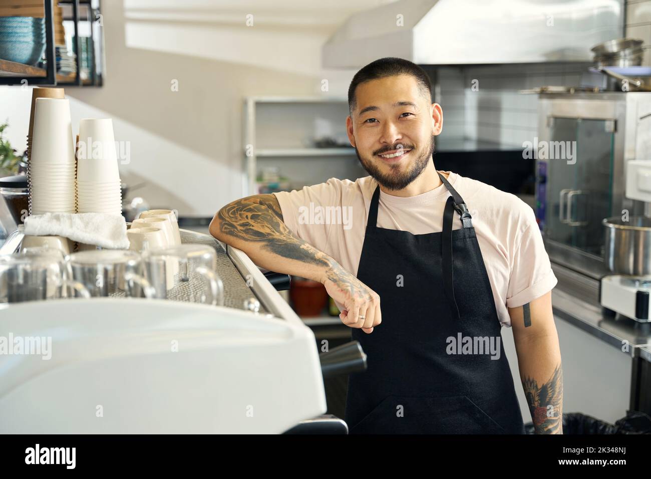 Amicable young man posing proudly in his coffee shop Stock Photo - Alamy