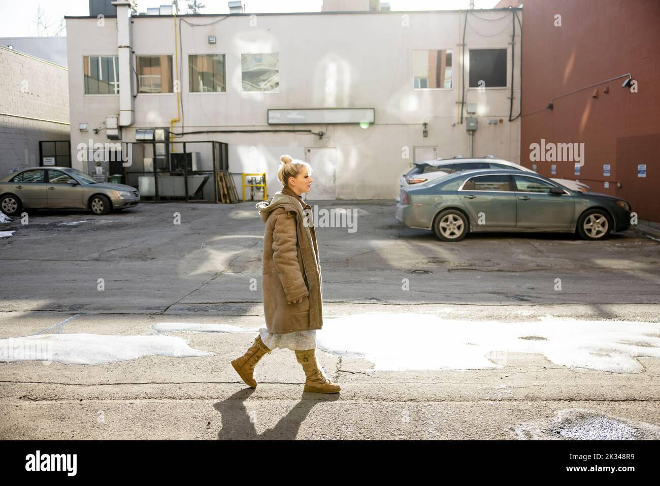 Woman walking coat hi-res stock photography and images - Alamy