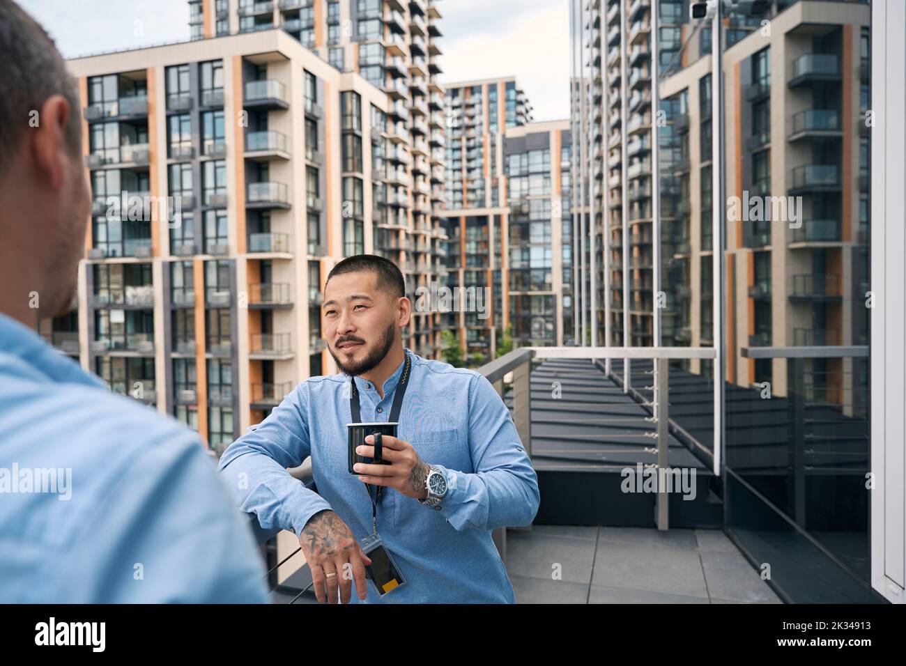 Office worker having conversation with his colleague during coffee ...