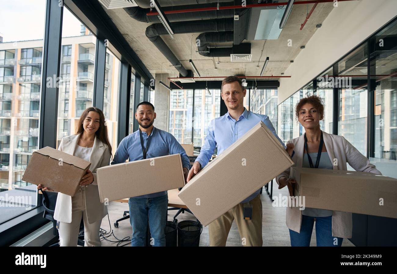 Joyous company staff posing for camera at work Stock Photo - Alamy