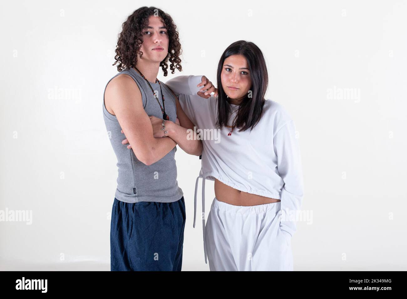 Portrait of a young couple dressed in yoga clothes looking ti the ...