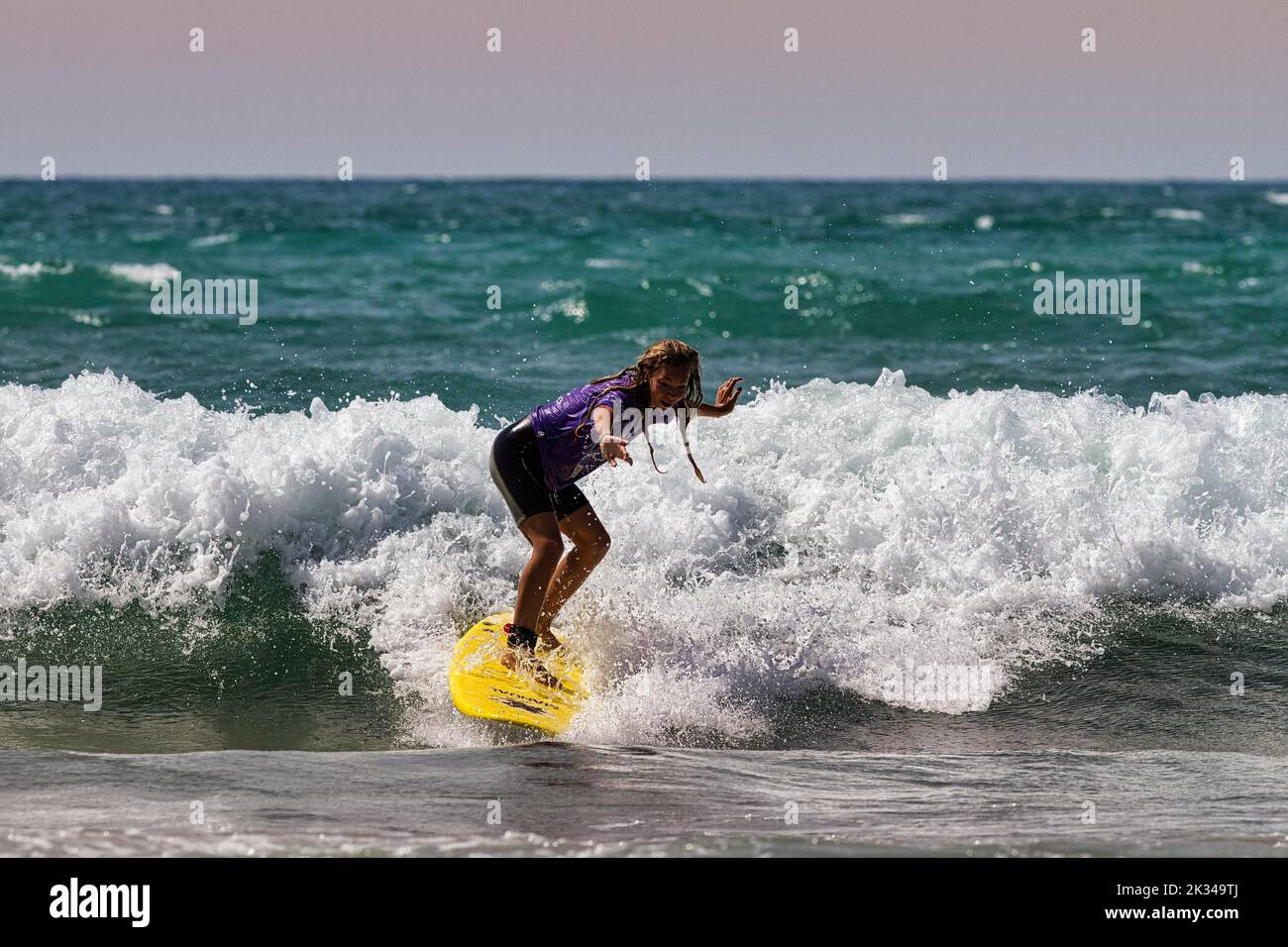Surf rider, surfer on a wave at the beach, surf school, back light ...