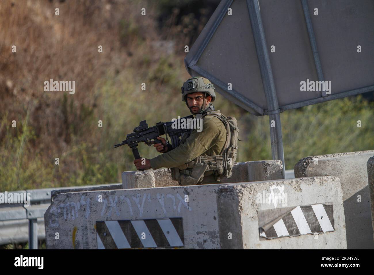 An Israeli soldier guarding at a checkpoint close to where a Palestinian, who they claim tried ...
