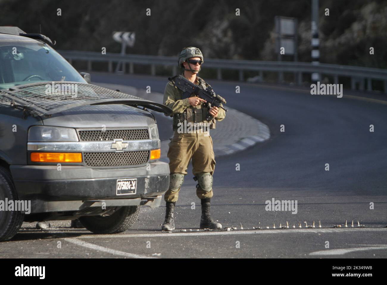 An Israeli soldier guarding at a checkpoint close to where a Palestinian, who they claim tried ...