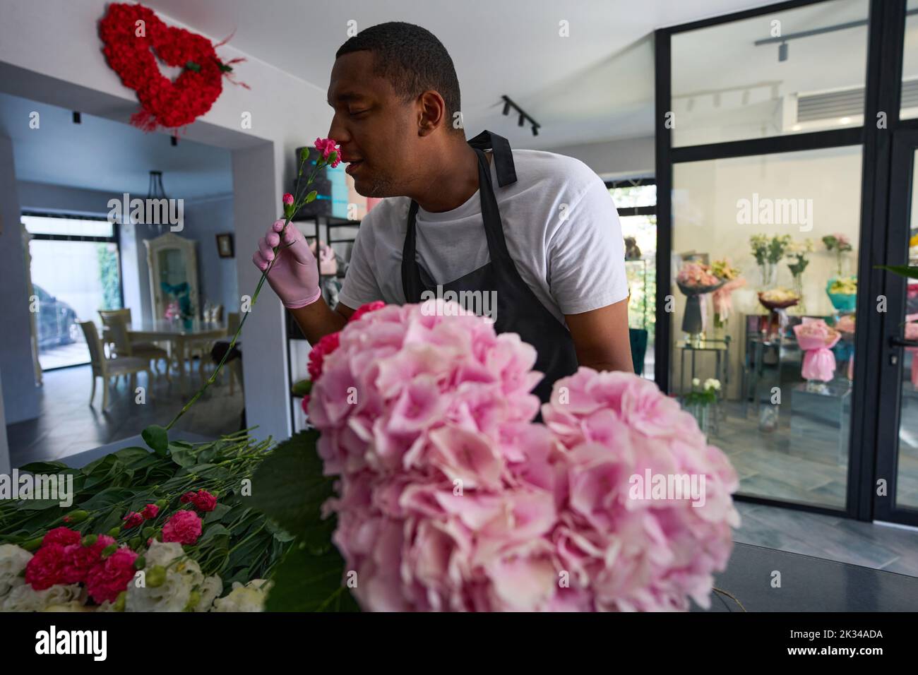 Man sniffing a flower hi-res stock photography and images - Alamy