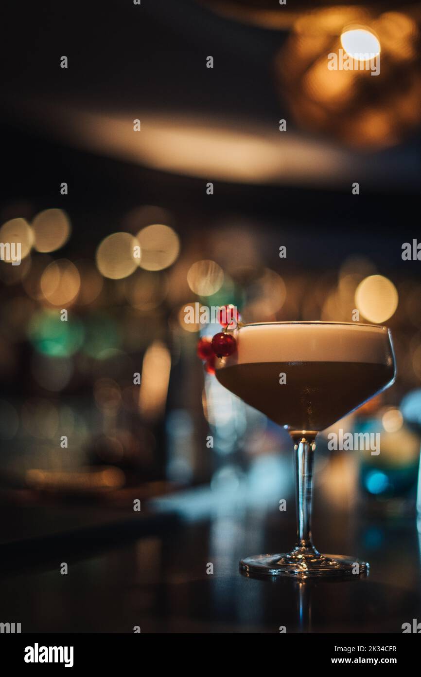 vertical photo of a cocktail in a cocktail bar after a bartender ...