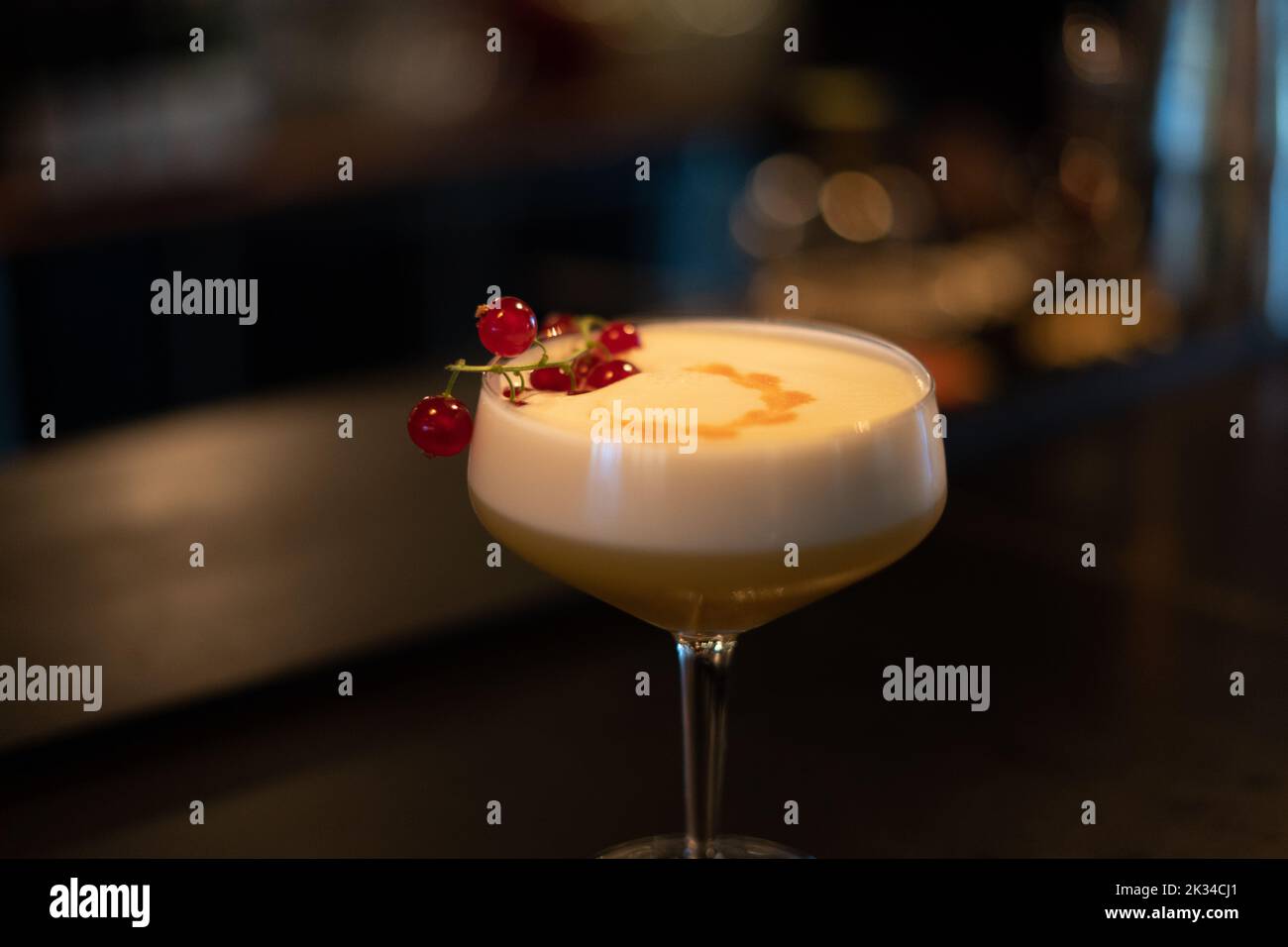 landscape photo of a cocktail at a bar with a cherry on top Stock Photo ...