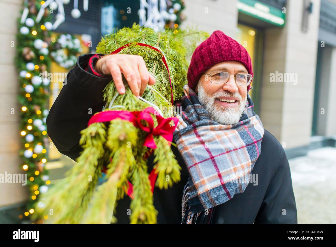 happy retired man walking by street with christmas tree to home from ...