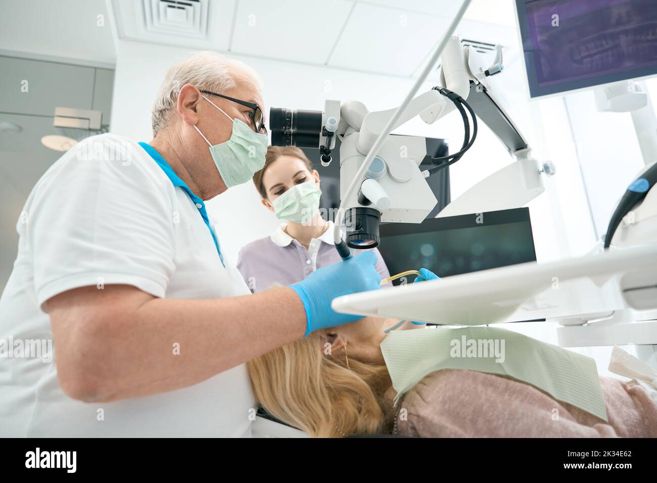 Stomatologist working with female patient and tools Stock Photo - Alamy