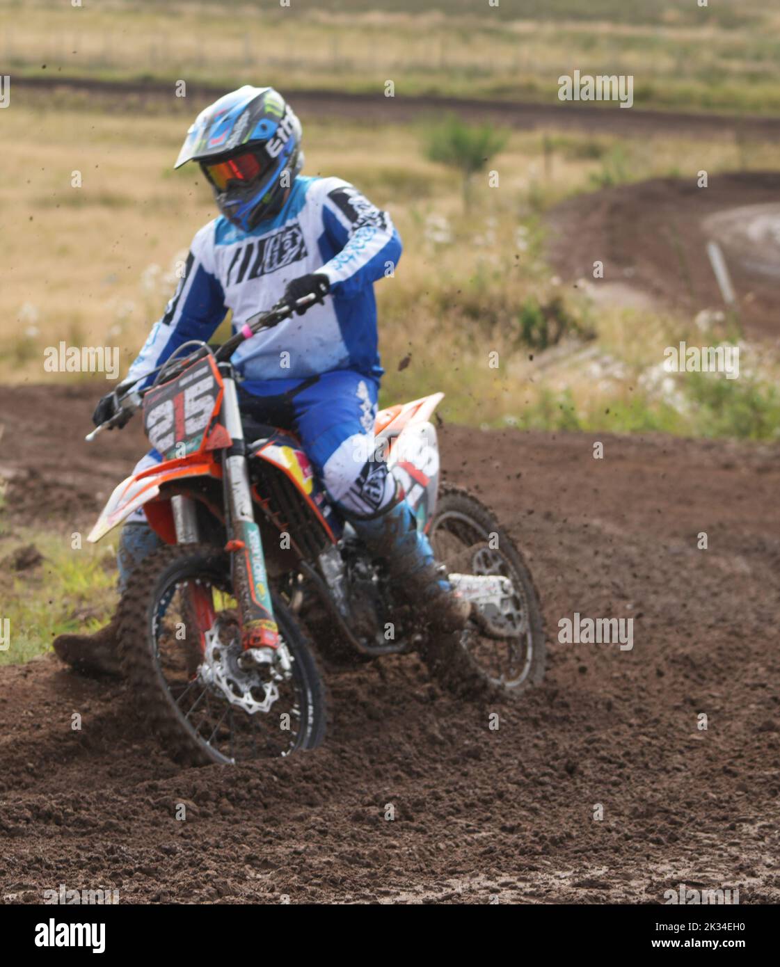 Rider on motocross bike racing around track Stock Photo - Alamy