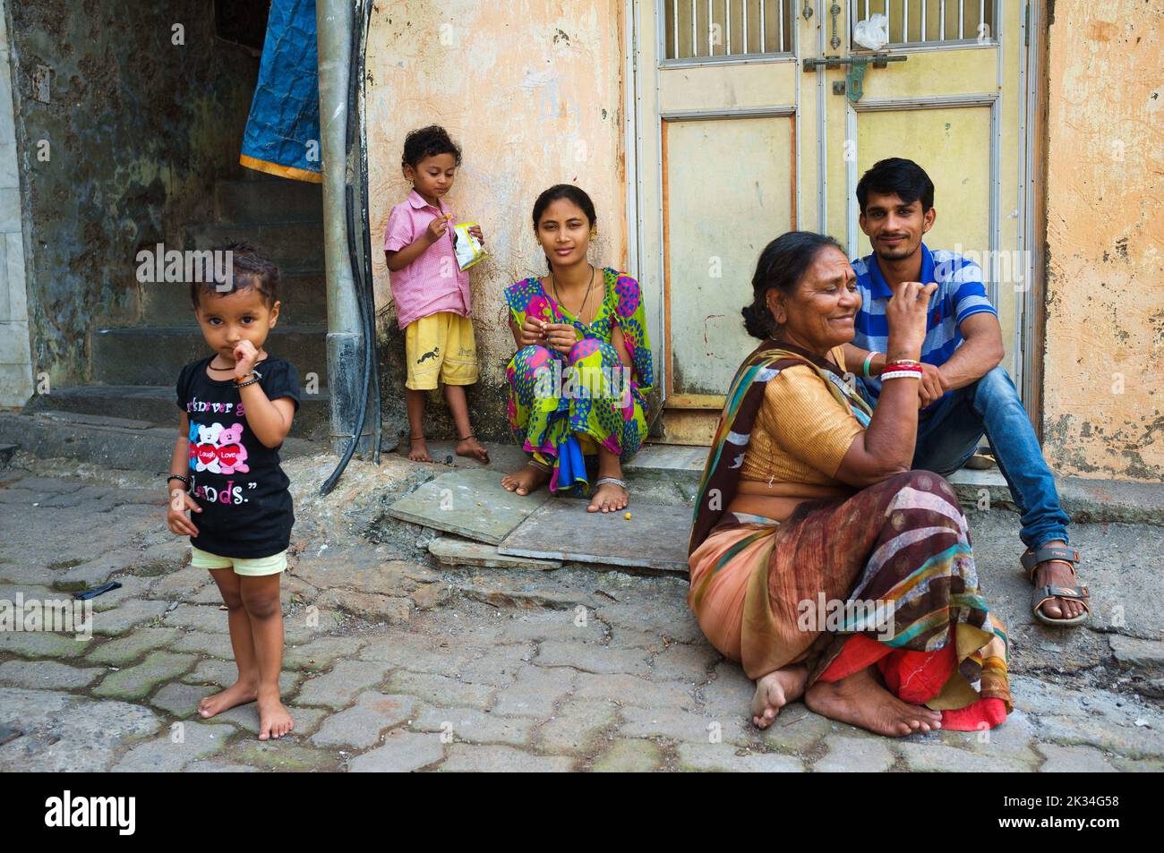 A happy and smiling Indian family from Banganga slum in Mumbai sitting ...