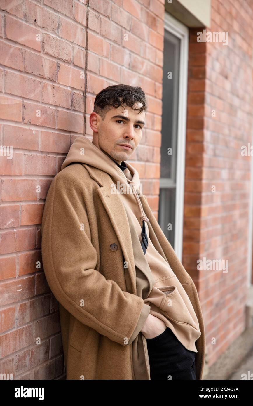 Portrait serious young man brick wall hi-res stock photography and ...