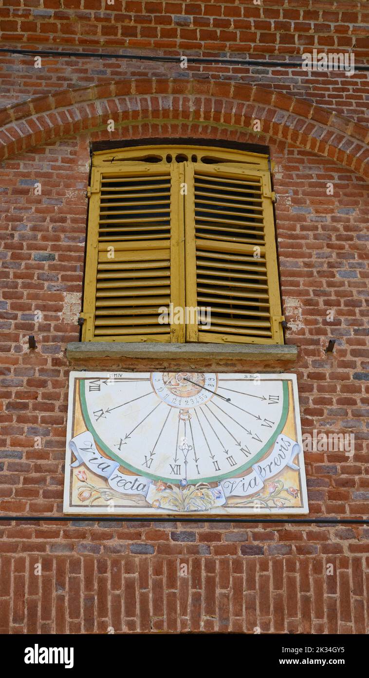 Pralormo, Italy, May 2022 Beautiful sundial painted on the wall of the ...