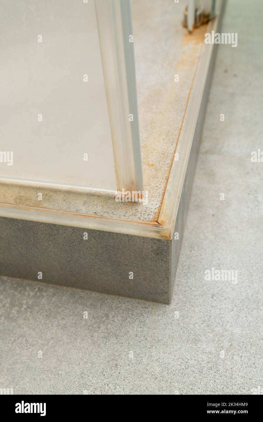 A close-up of the mechanism and joints of a shower stall screen with ...