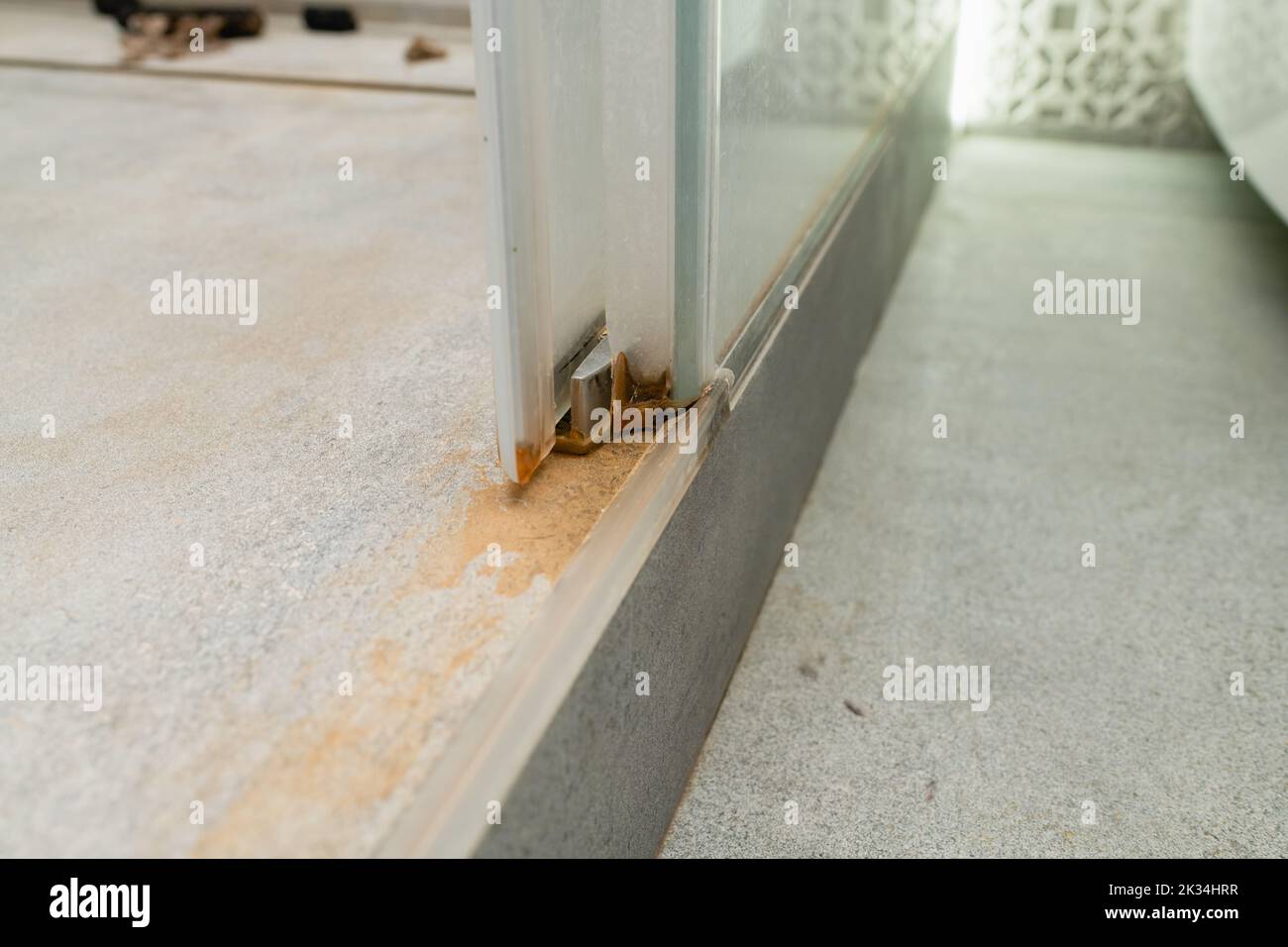 A close-up of the mechanism and joints of a shower stall screen with ...