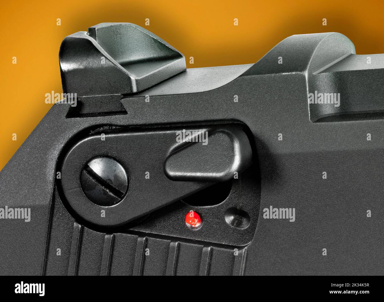 Semi-automatic handgun with its safety off on brown with dropshadow ...