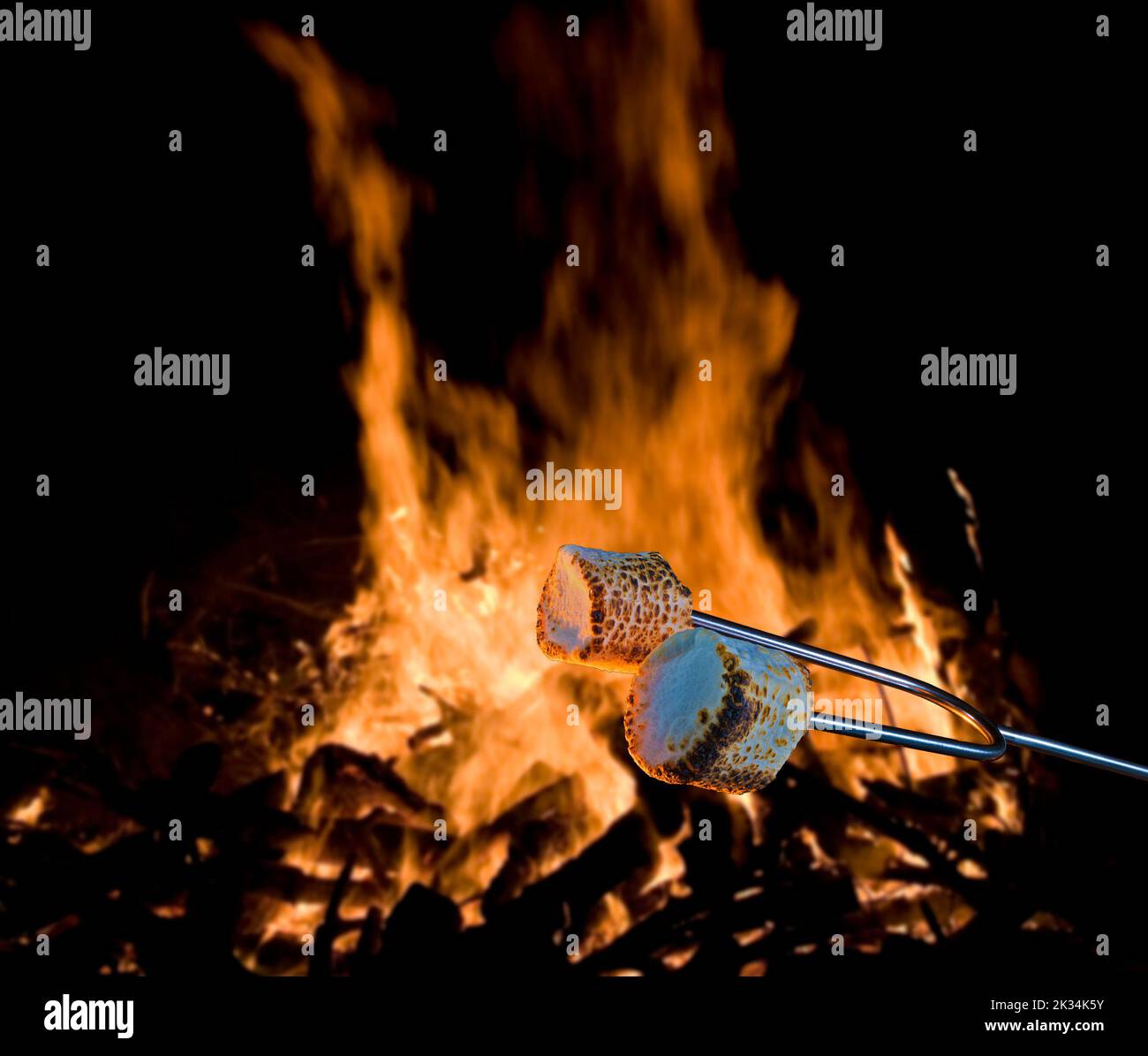 Pair of marshmallows roasting over an open fire to make smores Stock ...