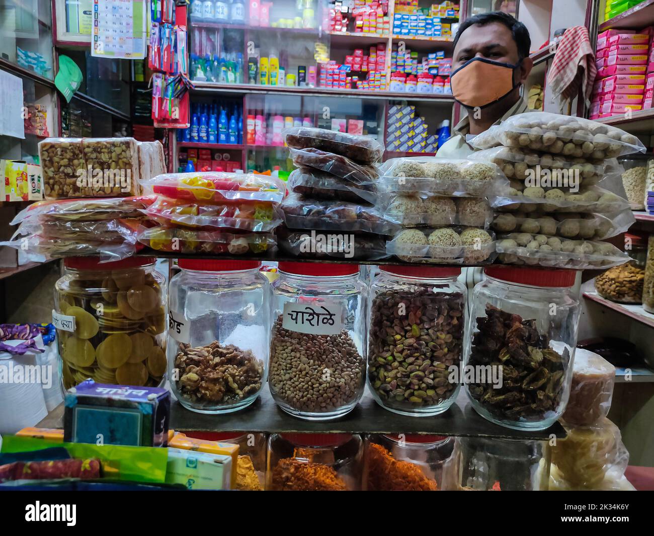 A closeup of an Indian Kirana groceries shop and an Indian merchant ...