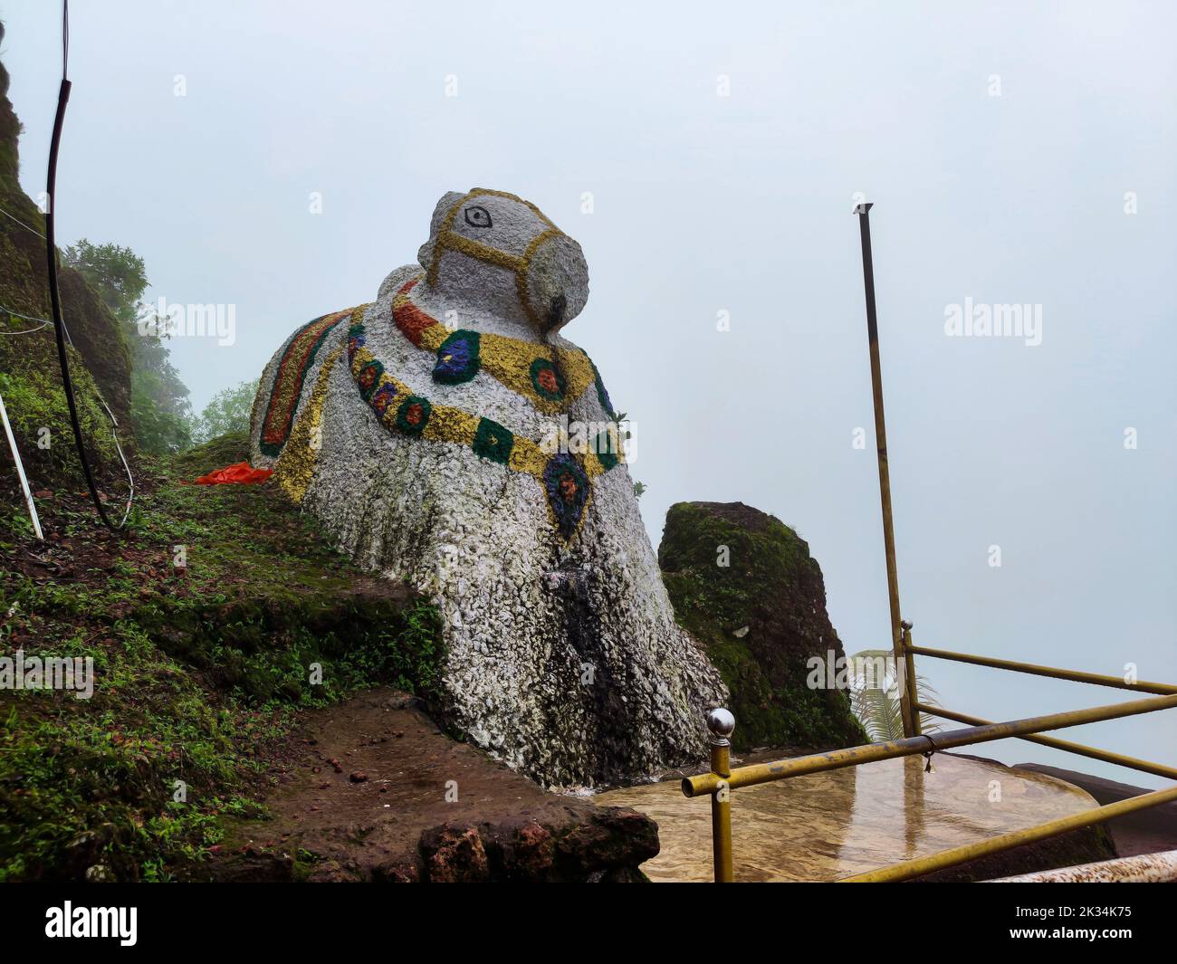 A closeup of a big ancient white color painted bull statue or Nandi at ...